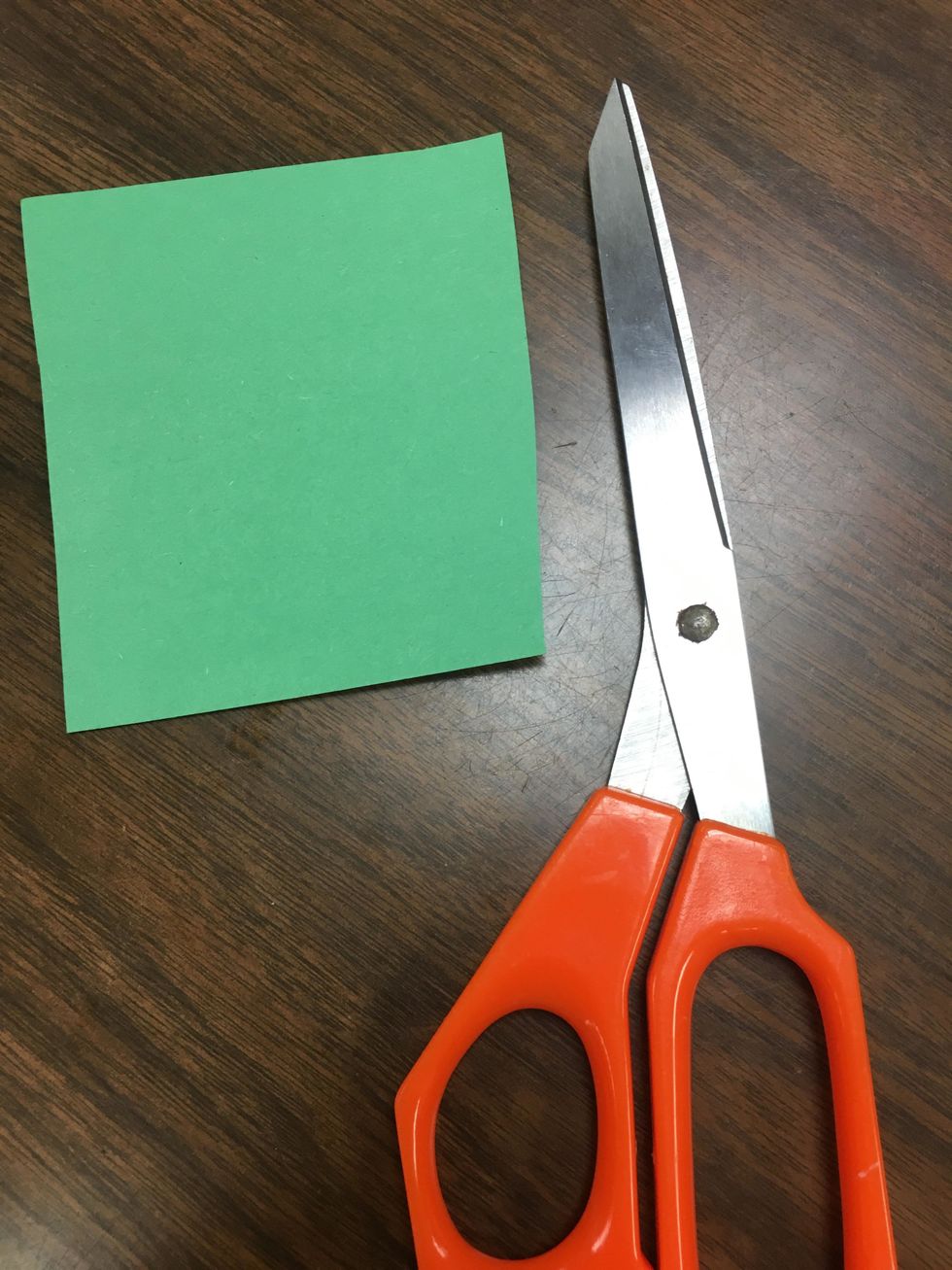 First, cut out a square of green construction paper. - B+C Guides