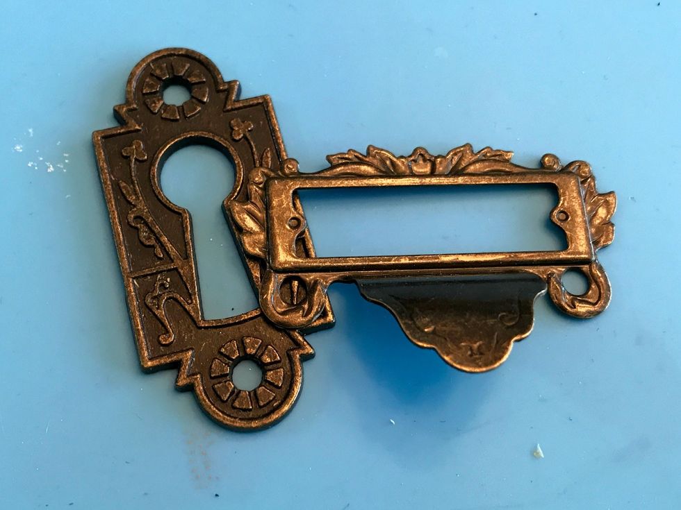 From the Ornate Metal Keyholes, select one keyhole from the pacakge ...