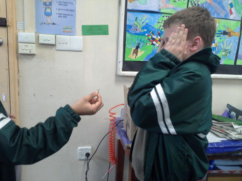 How to do the coin out of the ear trick - B+C Guides